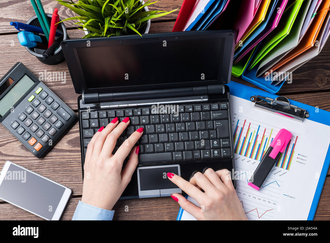 Office desktop with graphs and charts, documents and modern digital ...