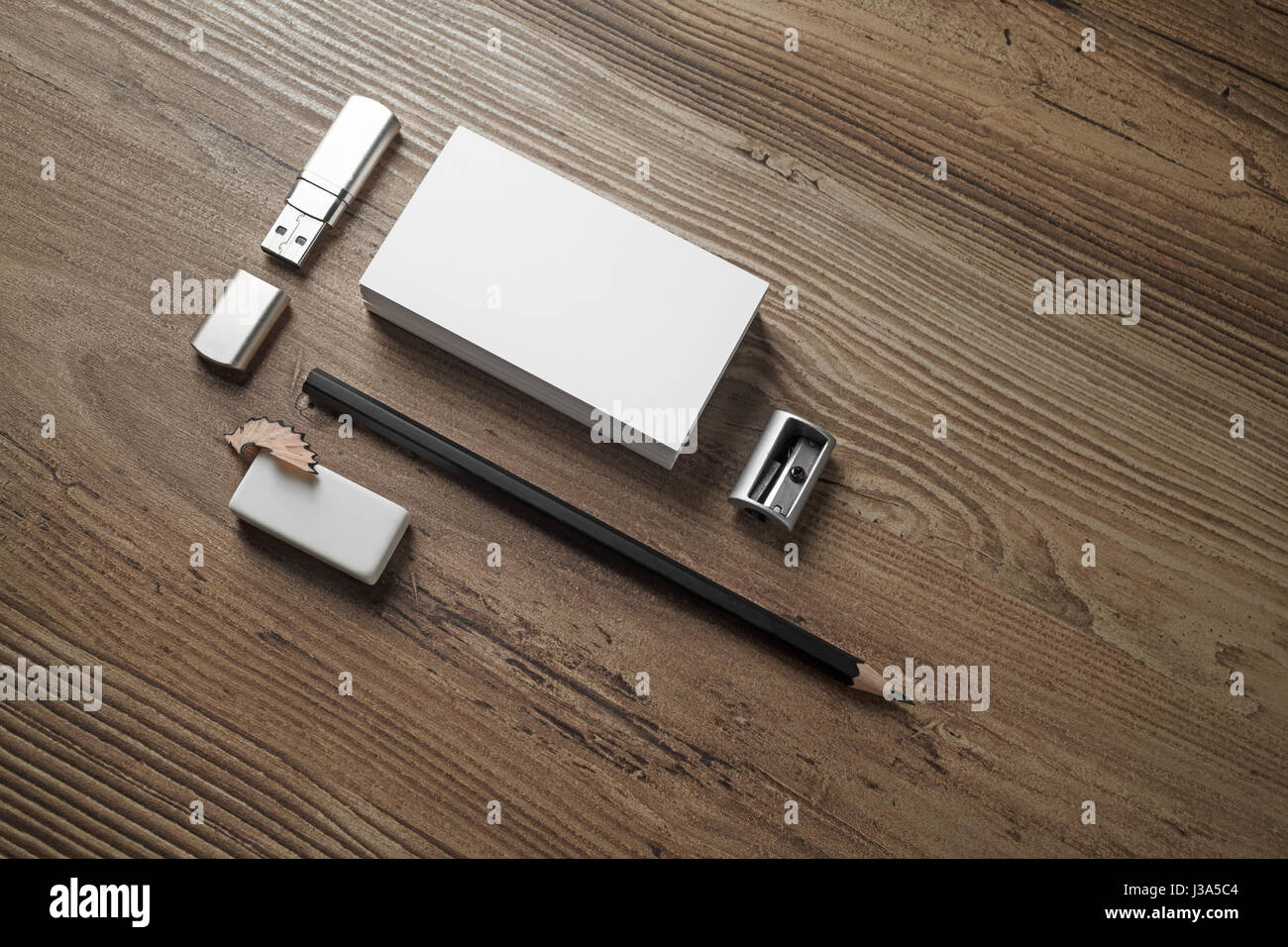 Bank business cards, pencil, eraser, flash drive and sharpener on ...