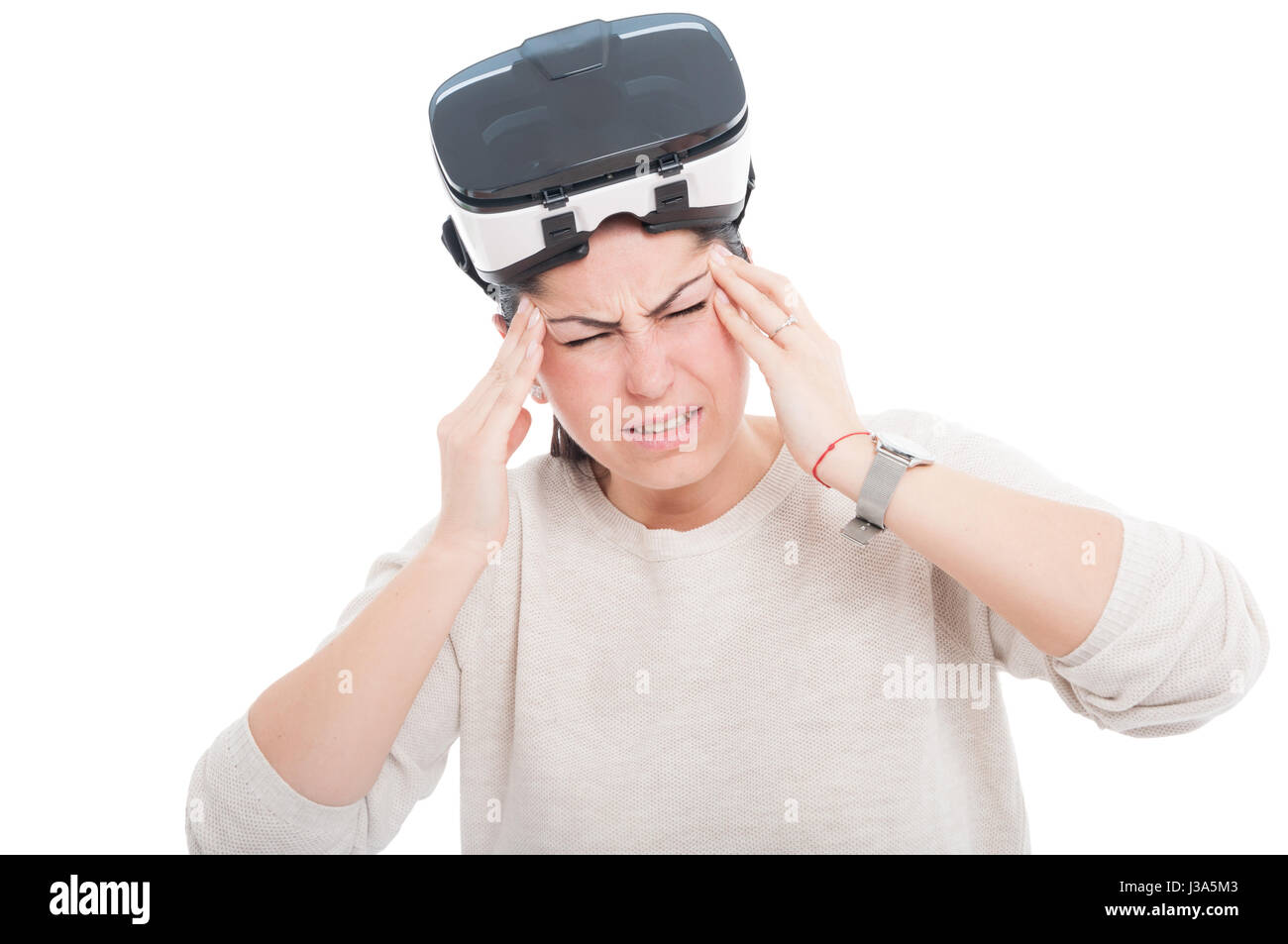 Young female looking exhausted or tired after using VR headset isolated ...