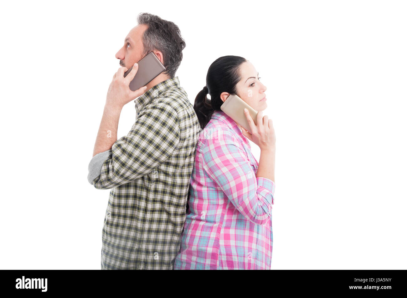 Lovers standing back to back and talking on cellphones with other ...