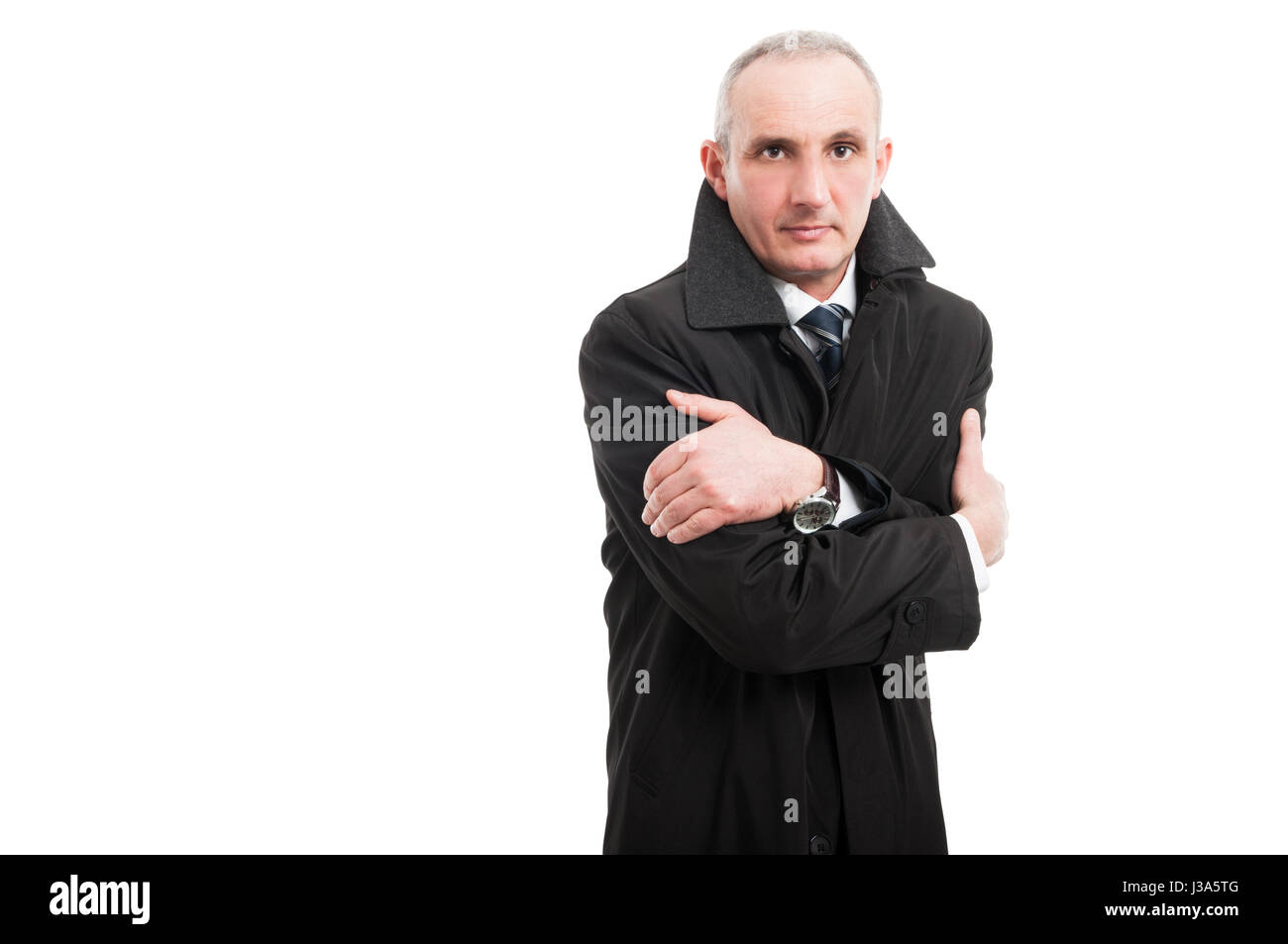 Middle age man wearing raincoat looking cold isolated on white ...