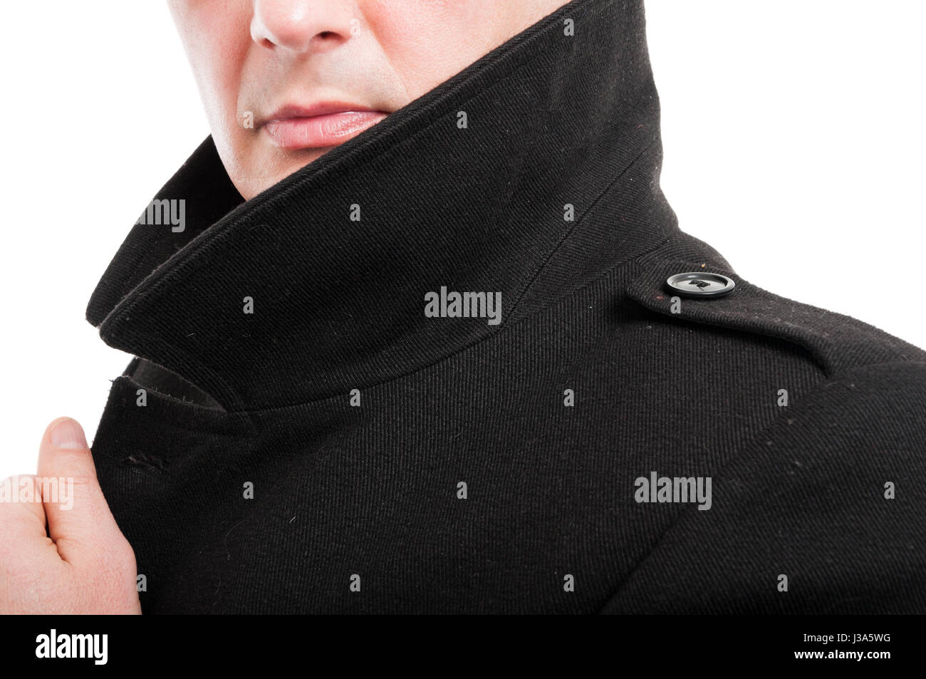 Close-up of elegant man posing with collar up isolated on white ...