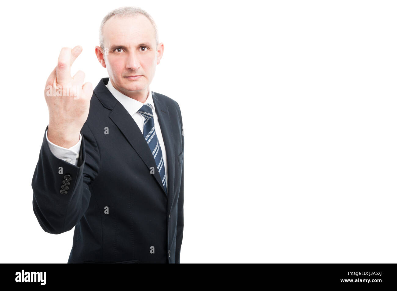Middle aged elegant man making fingers crossed gesture wearing suit and ...