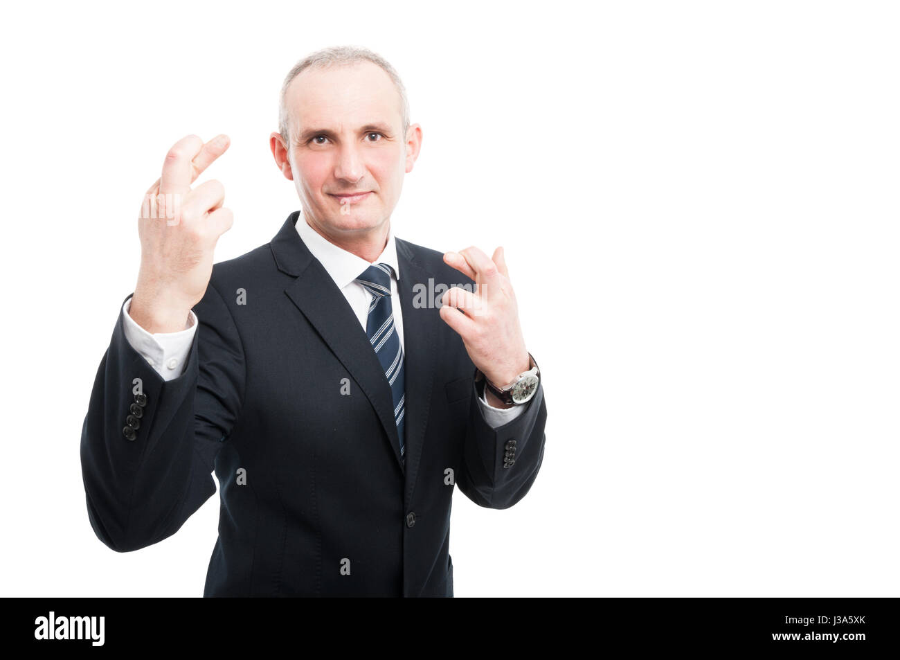Middle aged elegant man making double fingers crossed gesture wearing ...