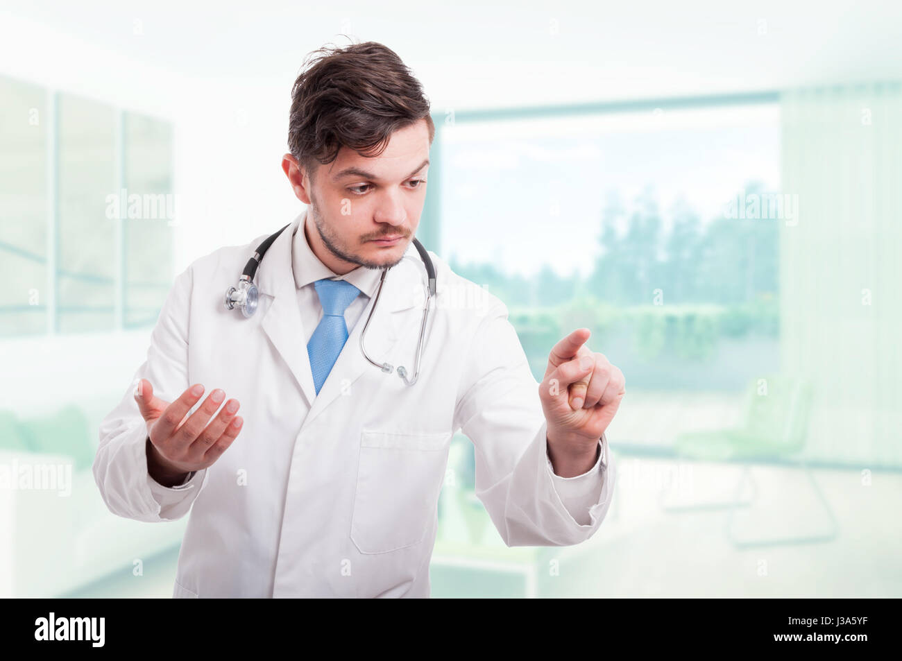 Professional doctor touching with finger a modern interface in his ...