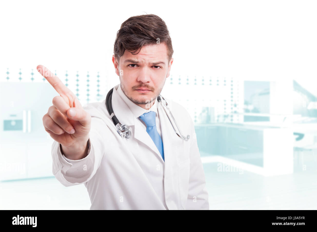 Serious doctor doing refusal or restriction gesture with copytext space ...