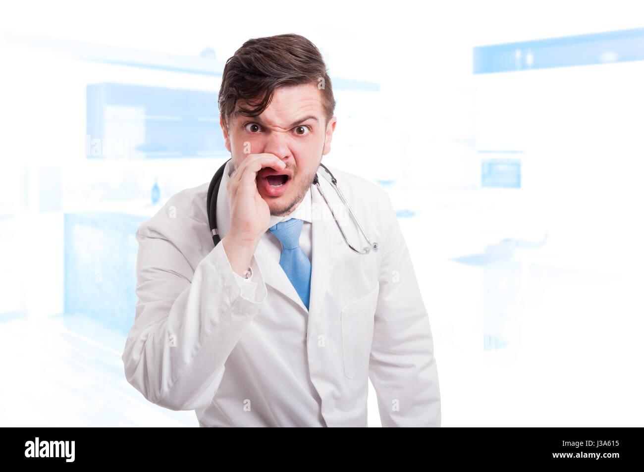 Frustrated doctor yelling with mouth open looking irritated Stock Photo ...