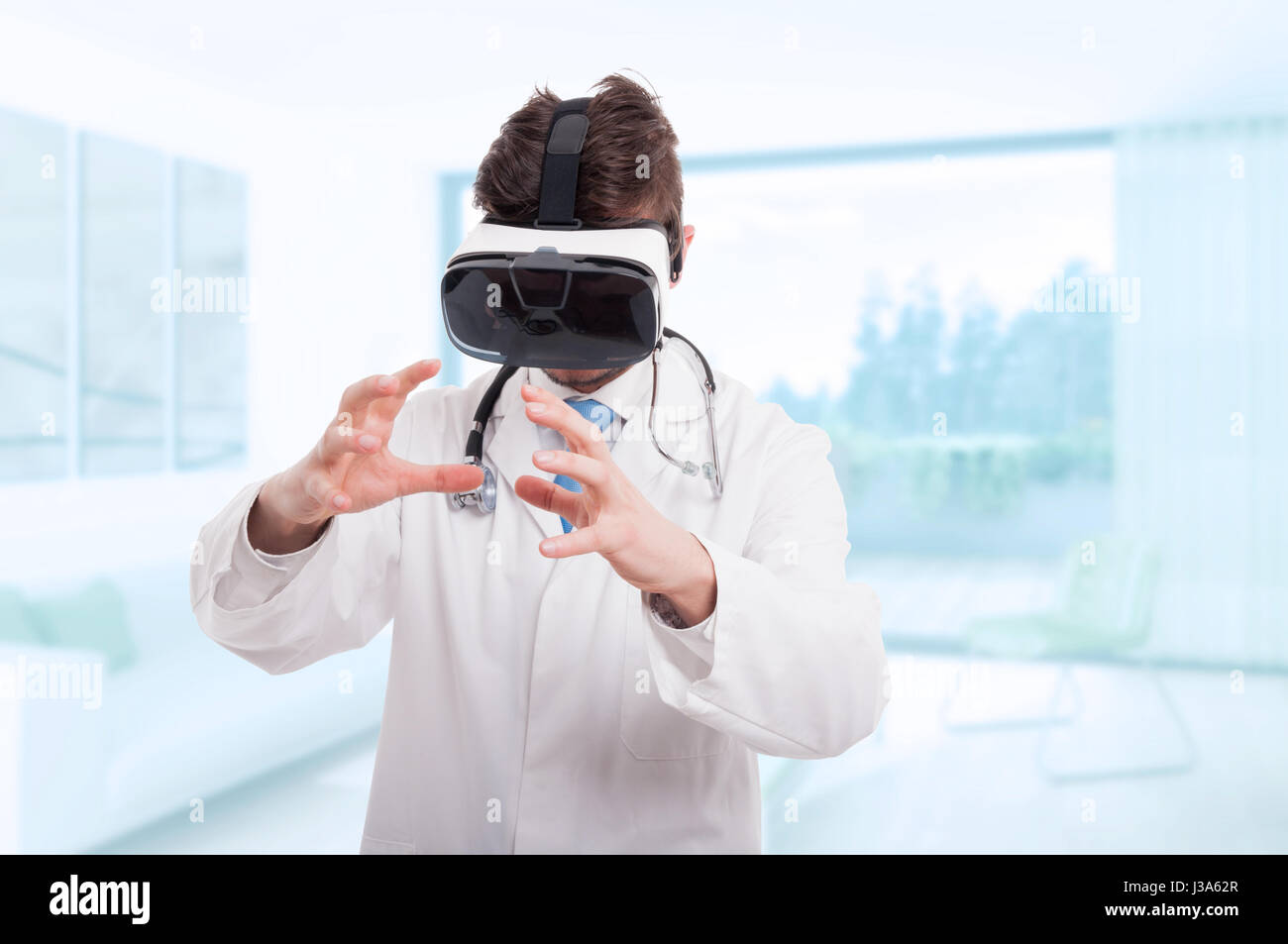 Medical doctor using virtual reality headset at the consulting room and ...
