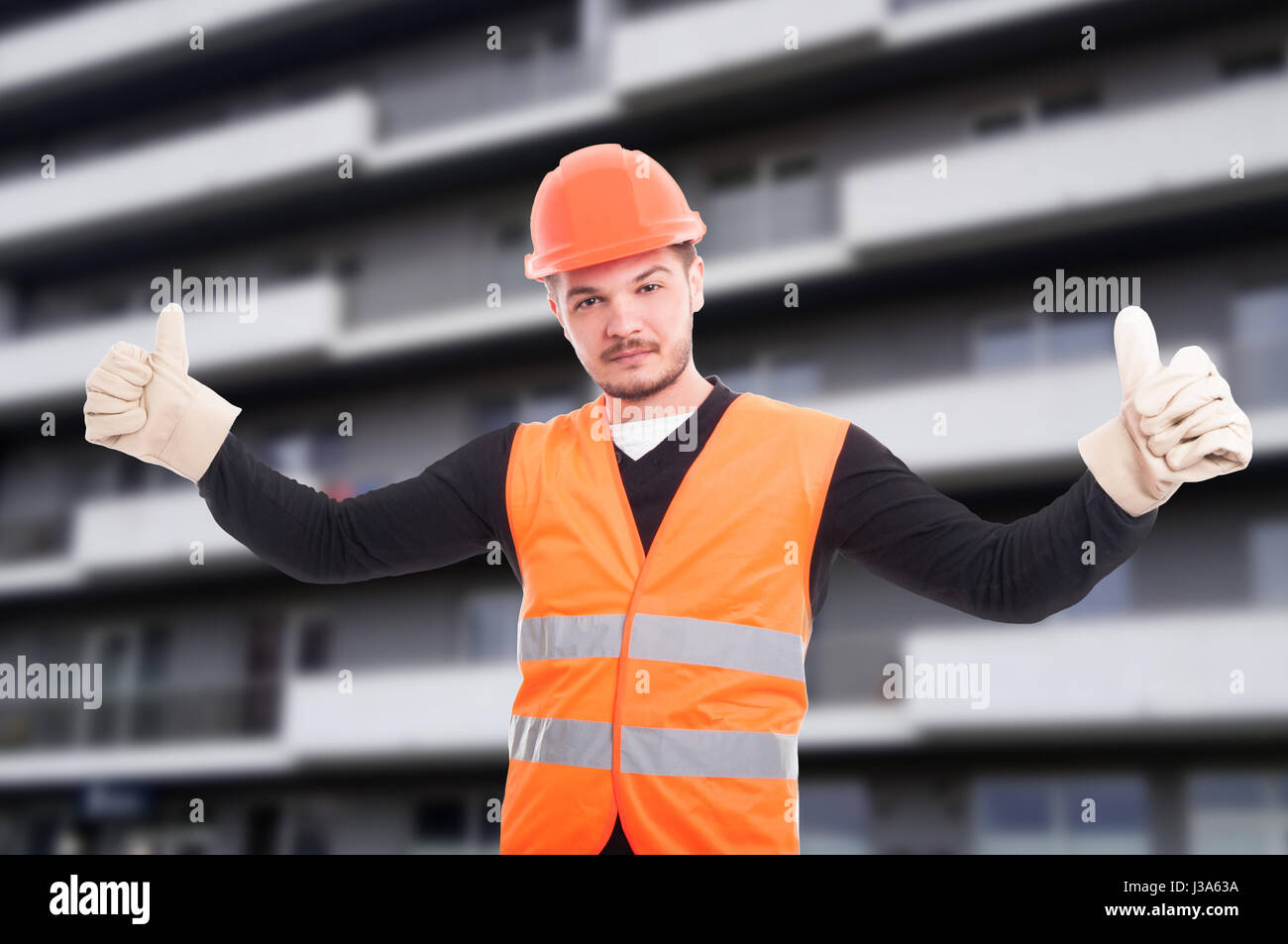 Successful builder shows double like sign with both hands on ...
