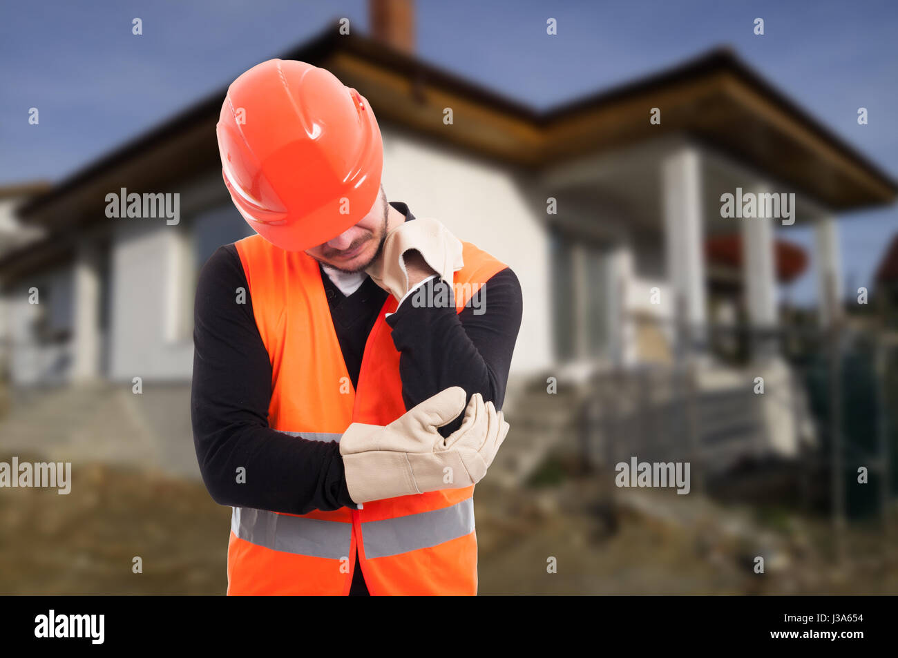 Construction worker suffering from elbow pain as muscle tension concept ...