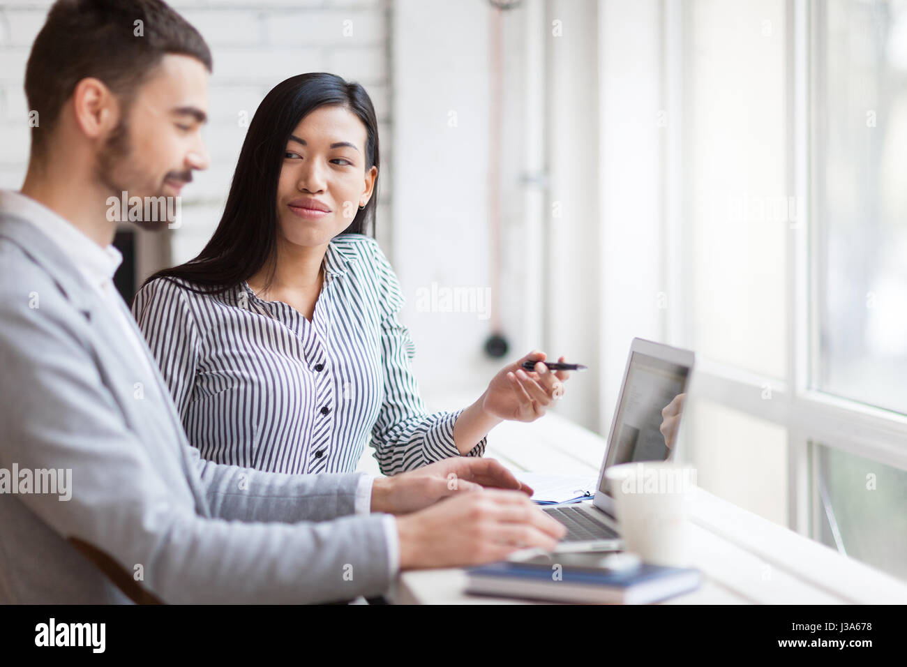 Productive Project Discussion with Colleague Stock Photo - Alamy
