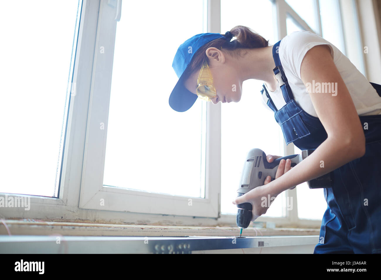 Female Worker Installing Windows Stock Photo - Alamy