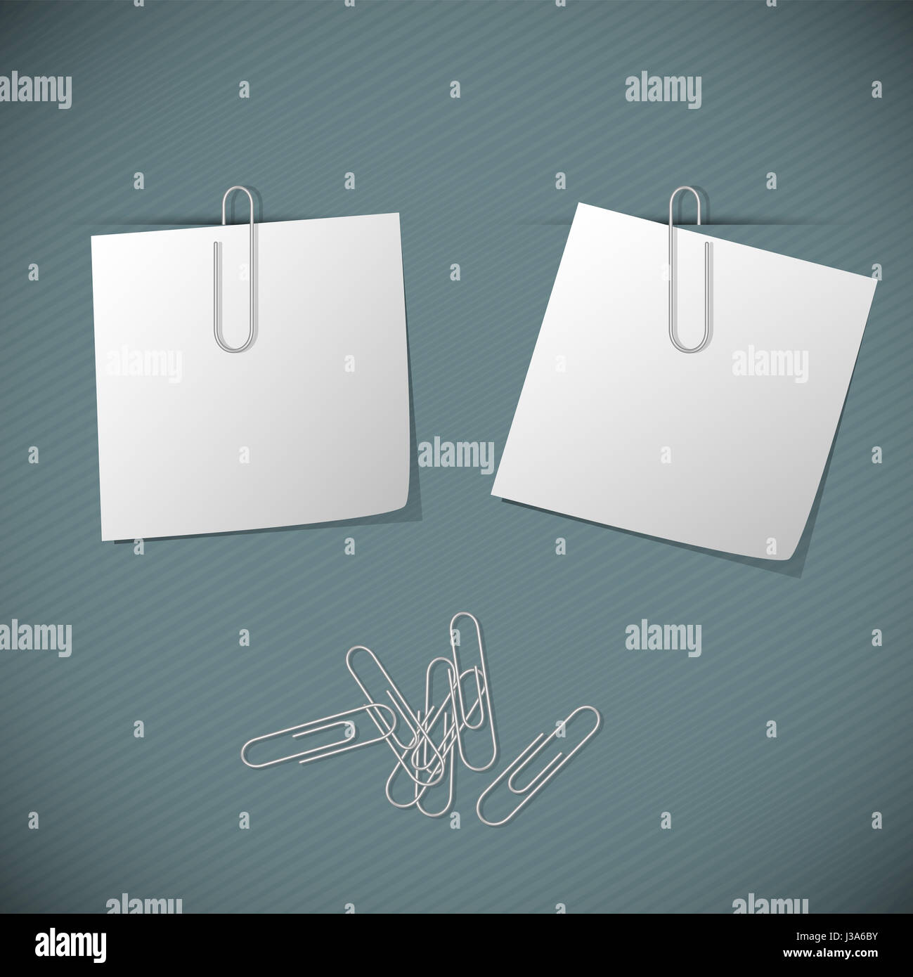 Two white post it with clips on a green background Stock Photo - Alamy