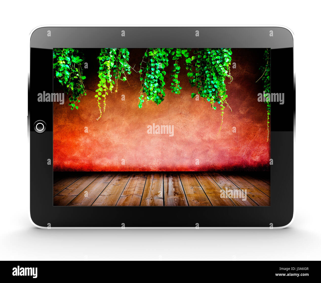 A tablet isolated on a white background with red wall and ivy Stock ...