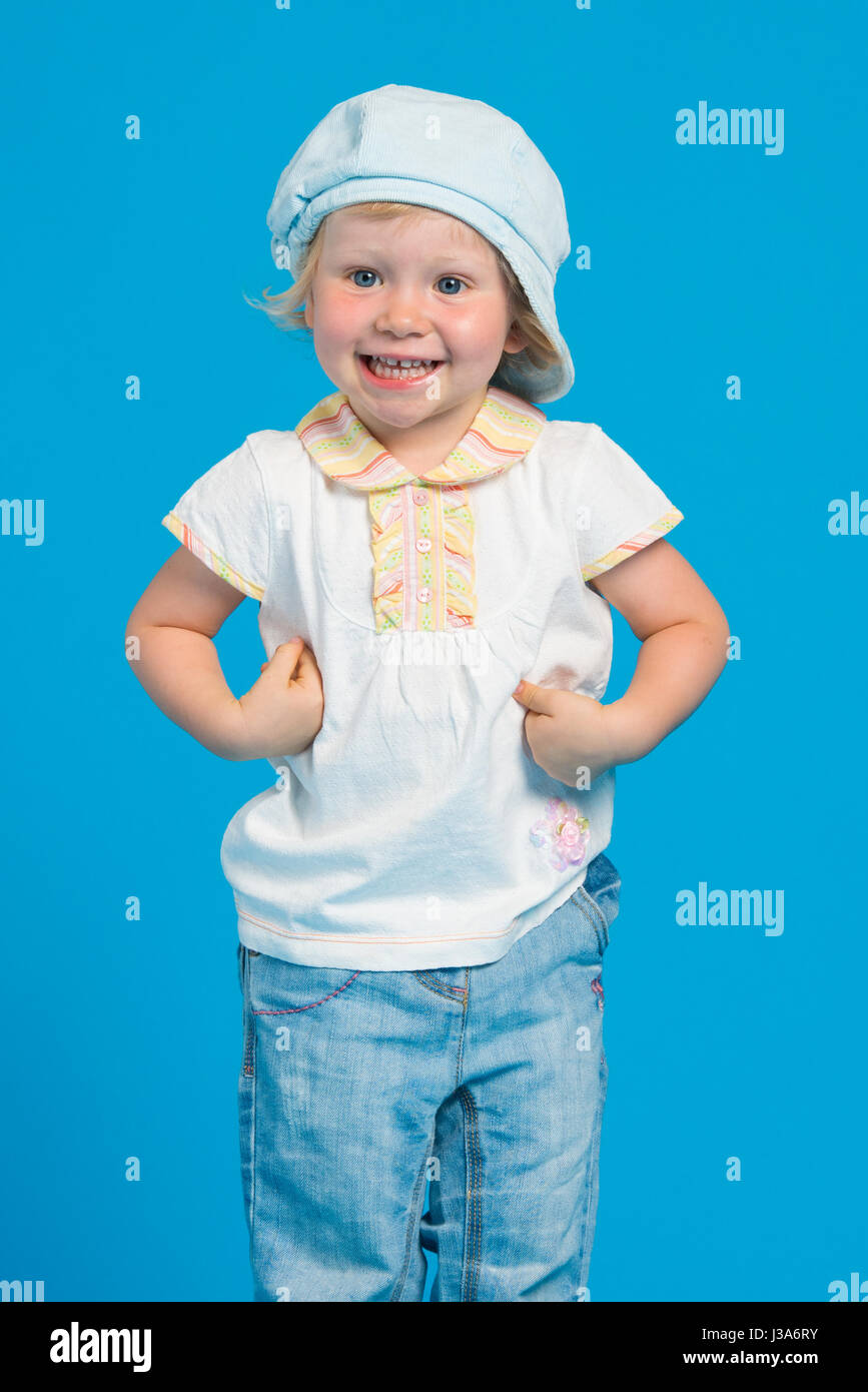Portrait of beautiful little girl against blue background Stock Photo ...