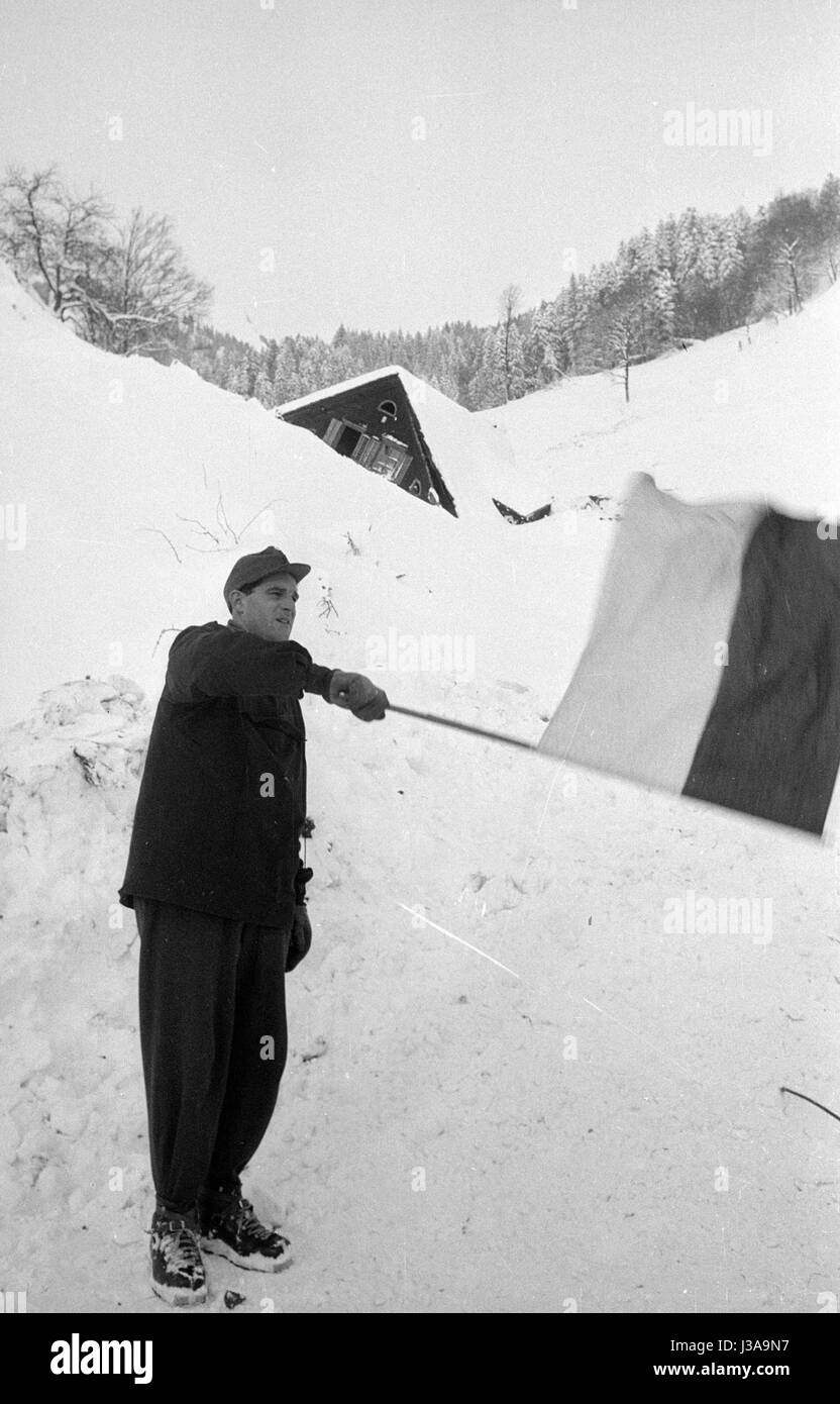 Helper in Blons giving signals with a signal flag, 1954 Stock Photo - Alamy