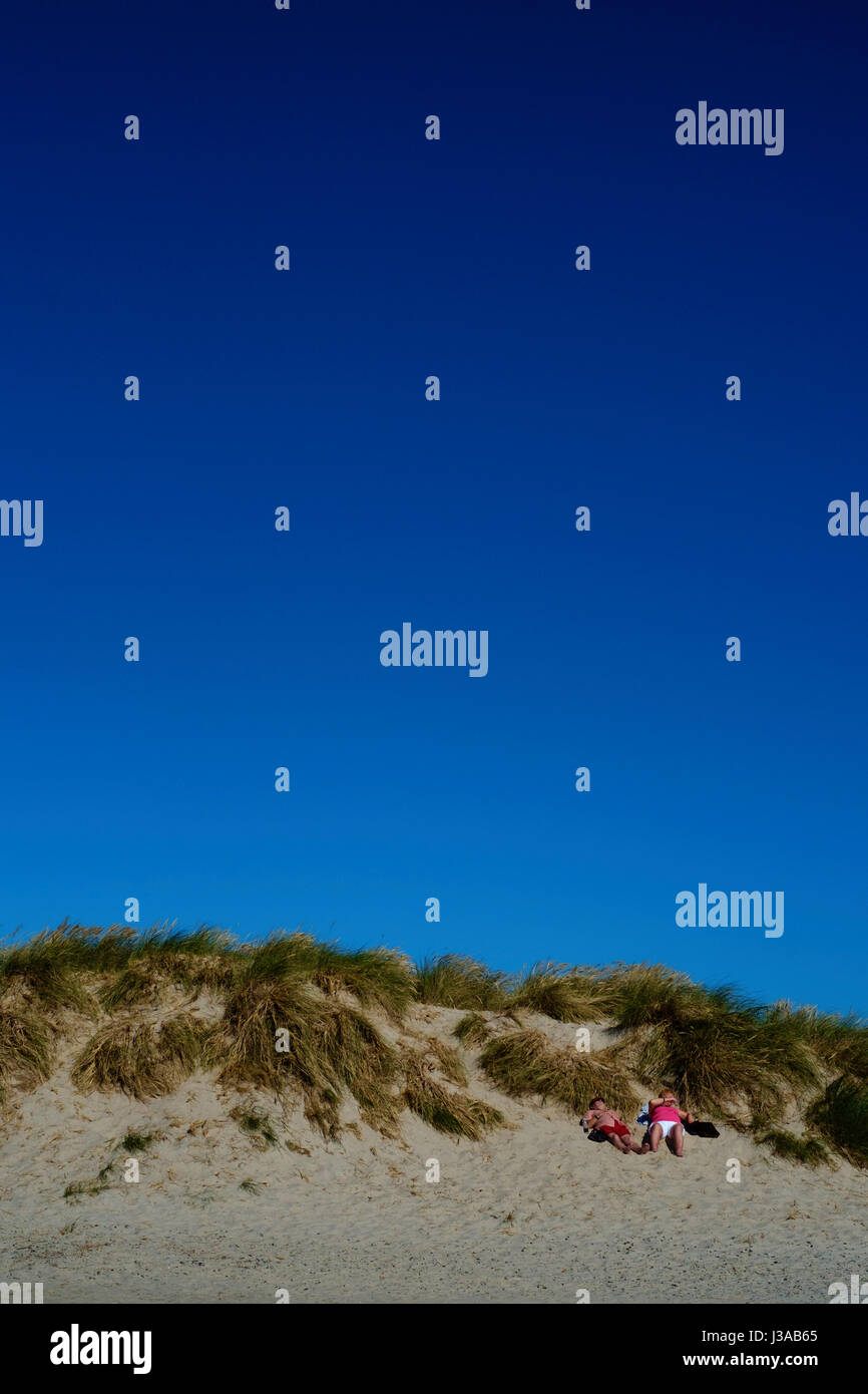 Couple sun bathing beach hi-res stock photography and images - Alamy