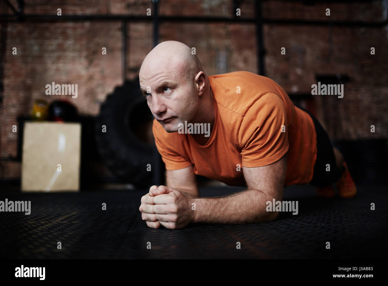 Doing Plank Exercise in Gym Stock Photo - Alamy