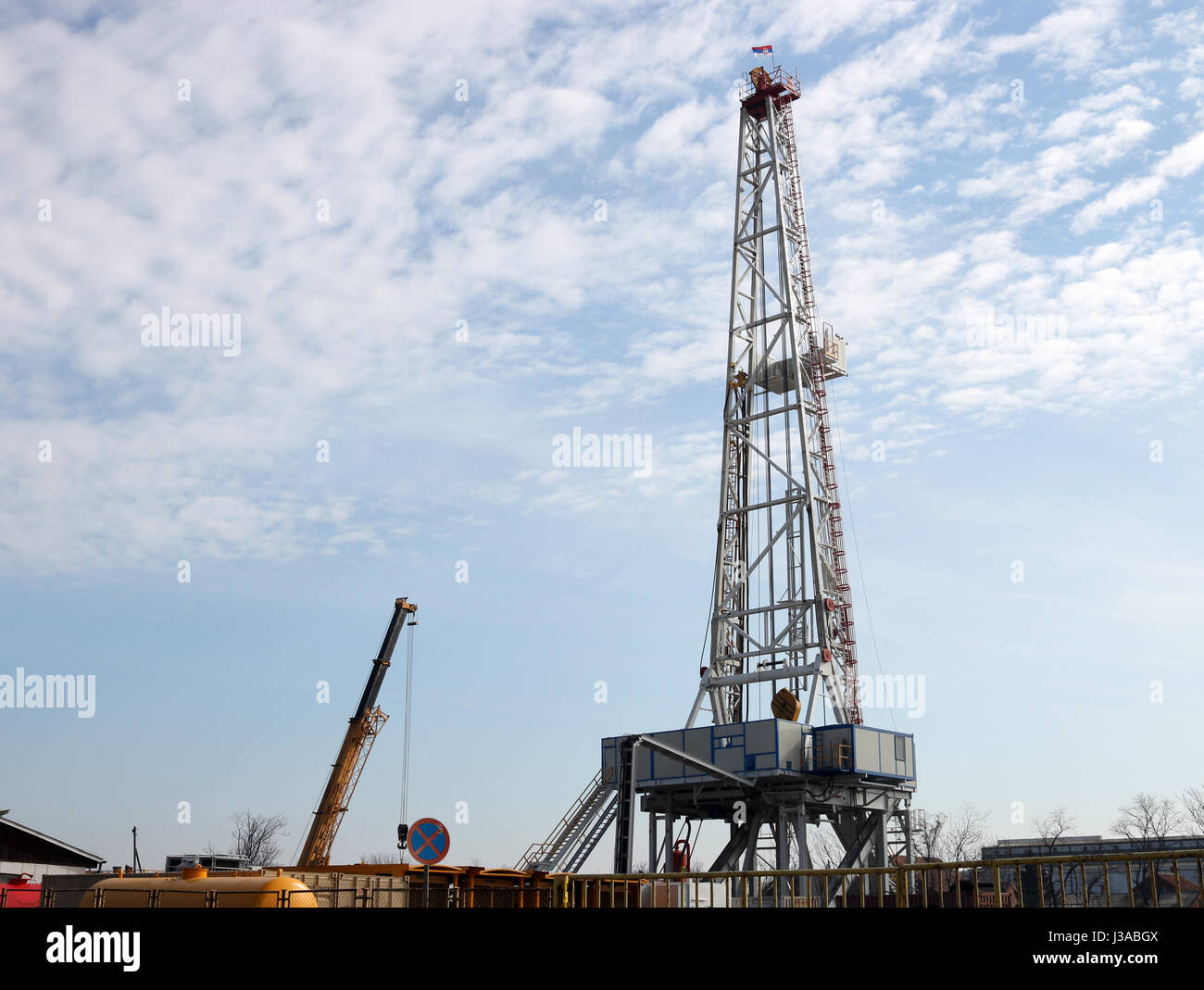 oil drilling rig and crane on field Stock Photo - Alamy
