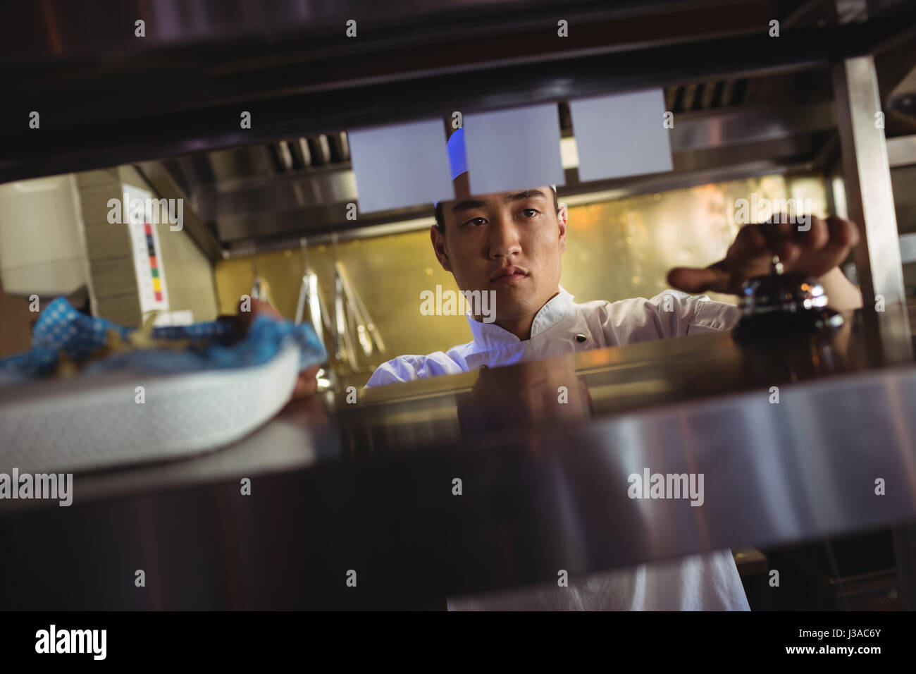 Chef ringing bell at order station in the commercial kitchen Stock ...