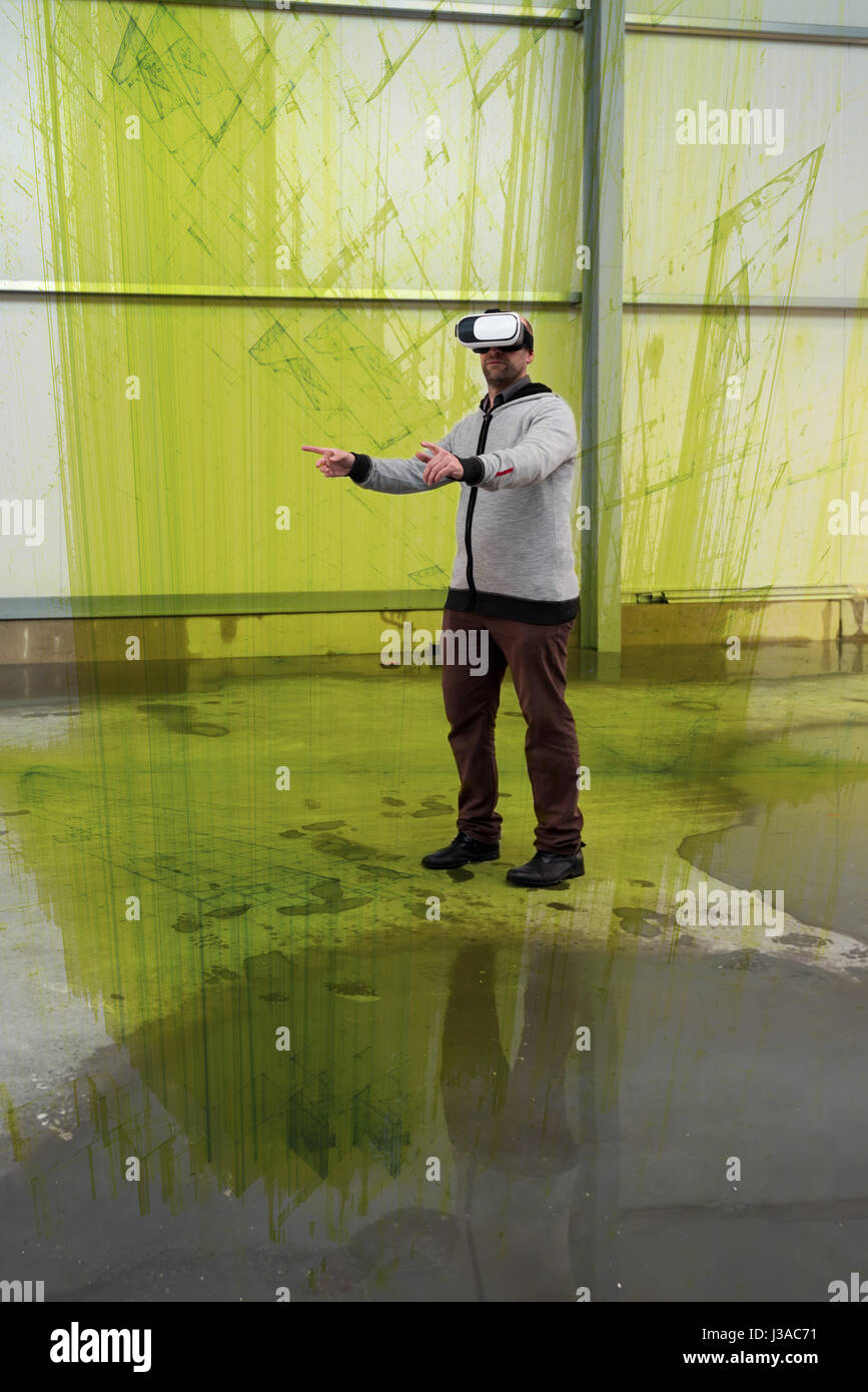 Architect with VR visor exploring industrial building environment Stock ...