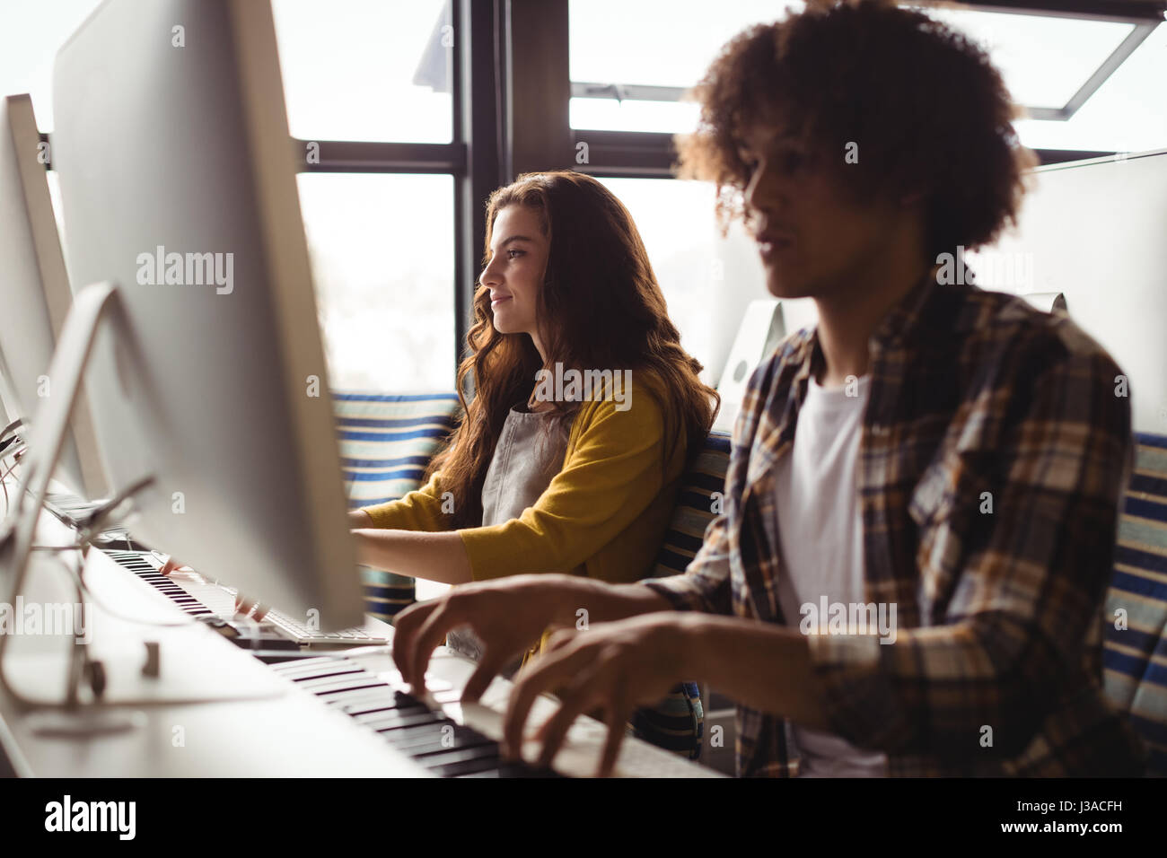 Audio engineers playing electric keyboard in recording studio Stock ...