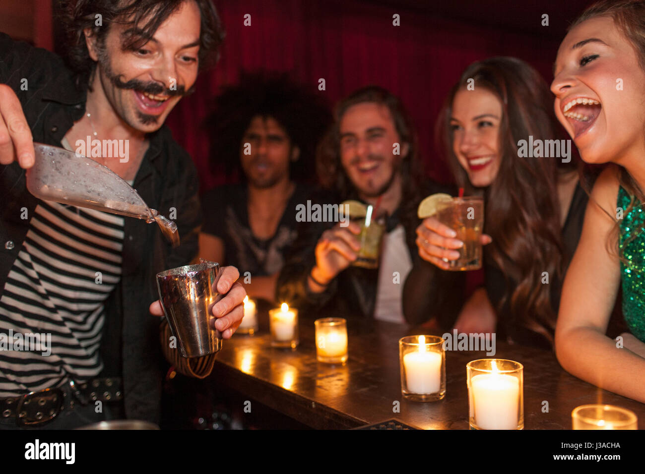 Bartender serving drinks at a nightclub Stock Photo - Alamy