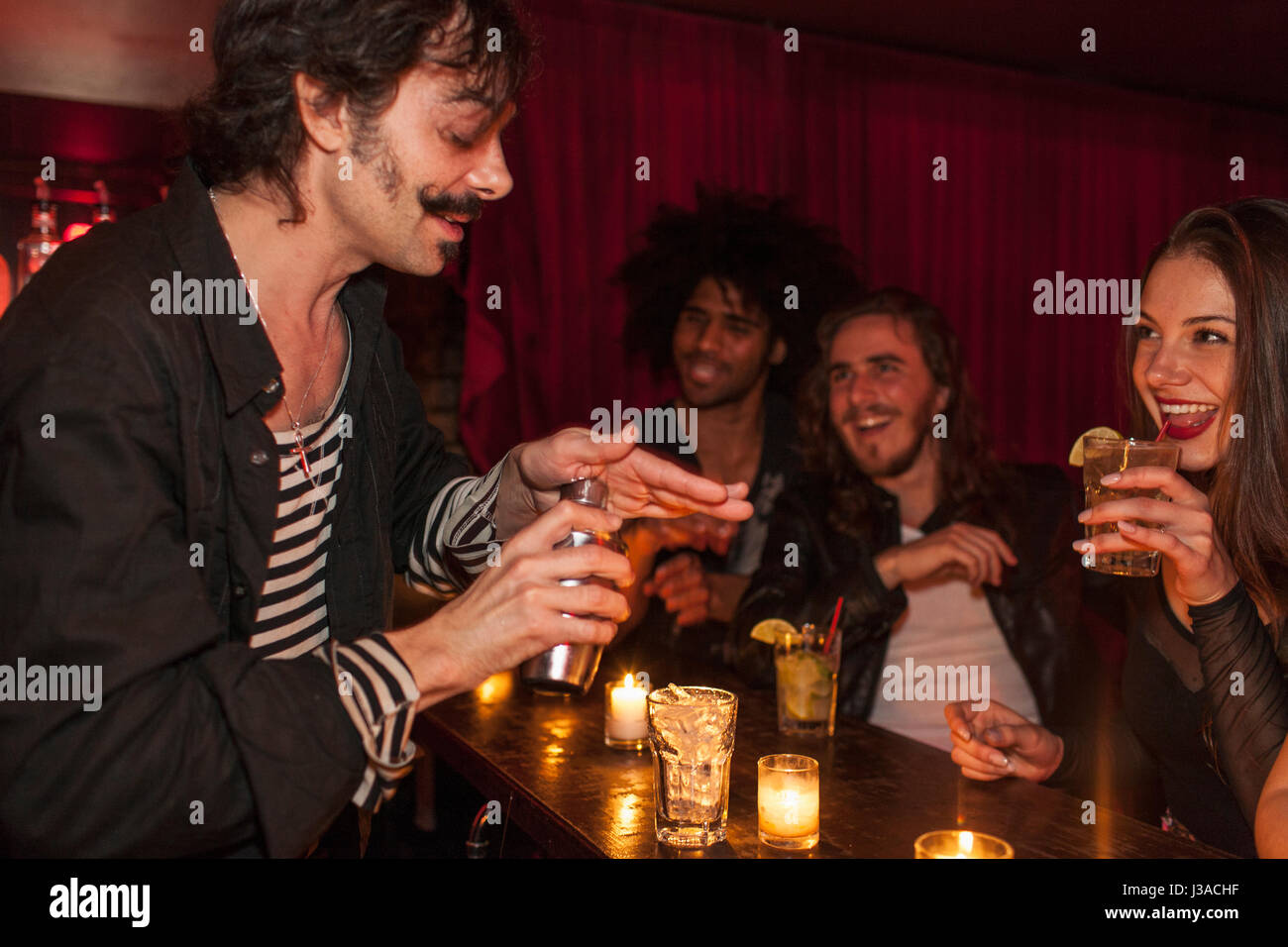 Bartender serving drinks at a nightclub Stock Photo - Alamy