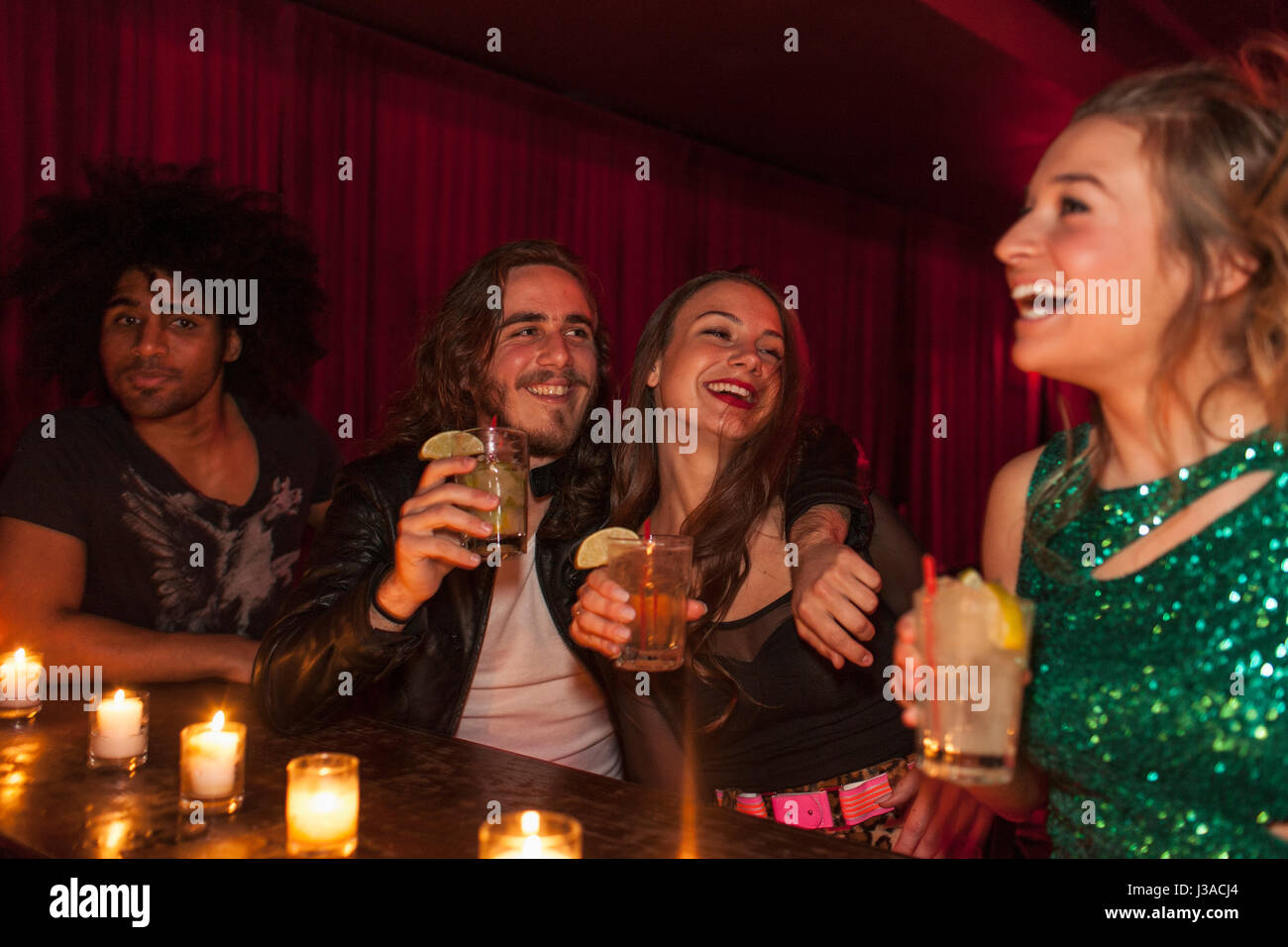 Friends hanging out at a nightclub Stock Photo - Alamy