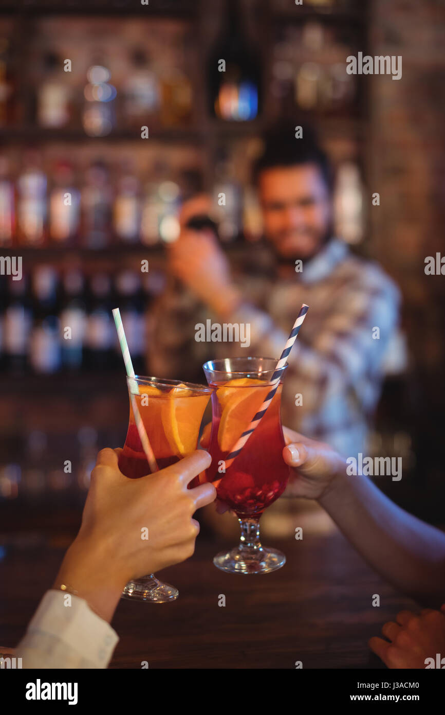 Hands of women toasting their cocktail drinks at counter in pub Stock ...