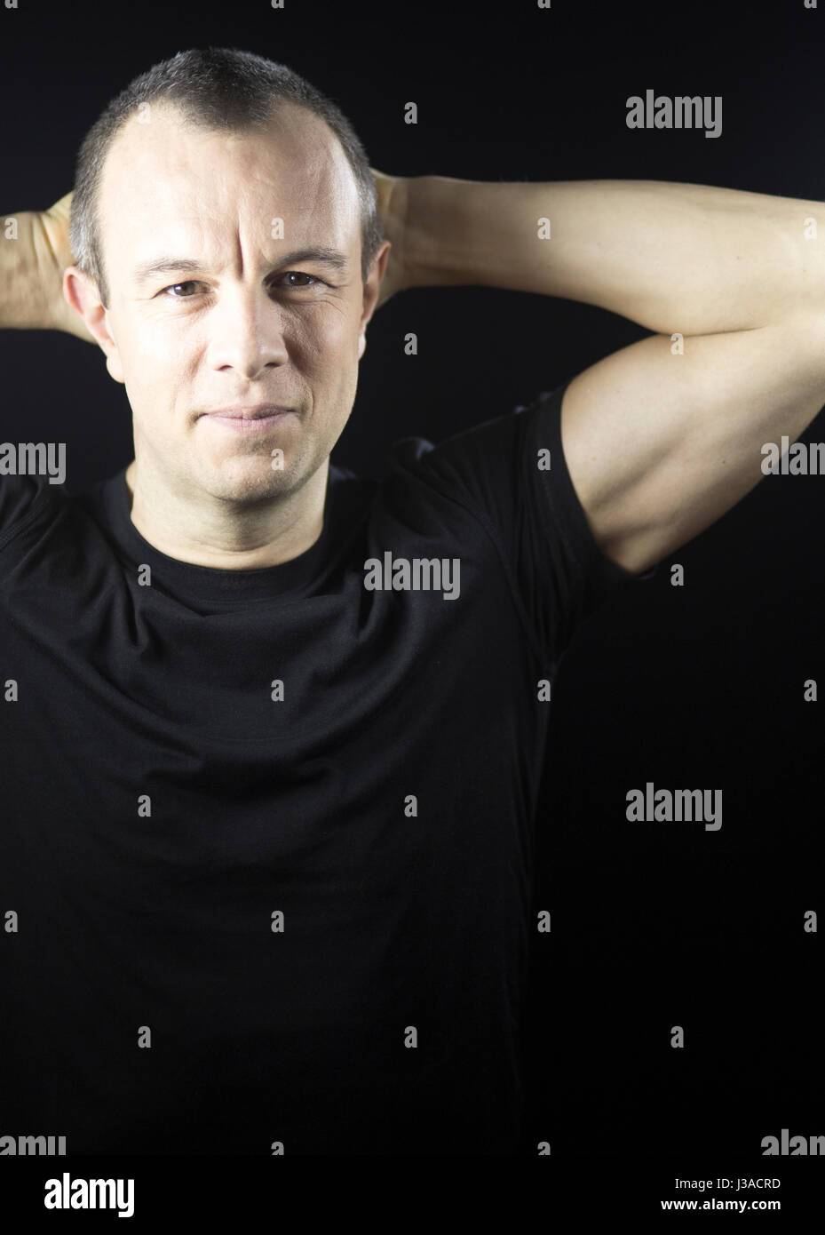 Attractive handsome slim healthy man aged in 40's in black t-shirt ...