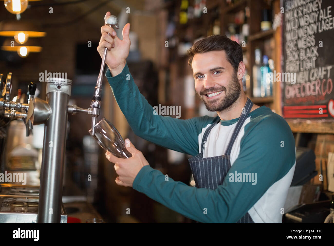 Bartender pouring beer from tap hi-res stock photography and images - Alamy