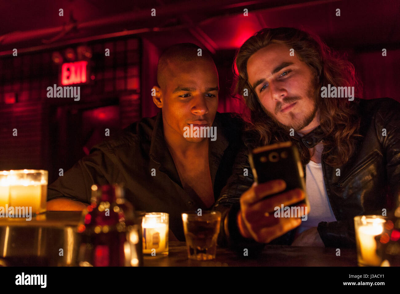 Young men hanging out at a nightclub Stock Photo - Alamy