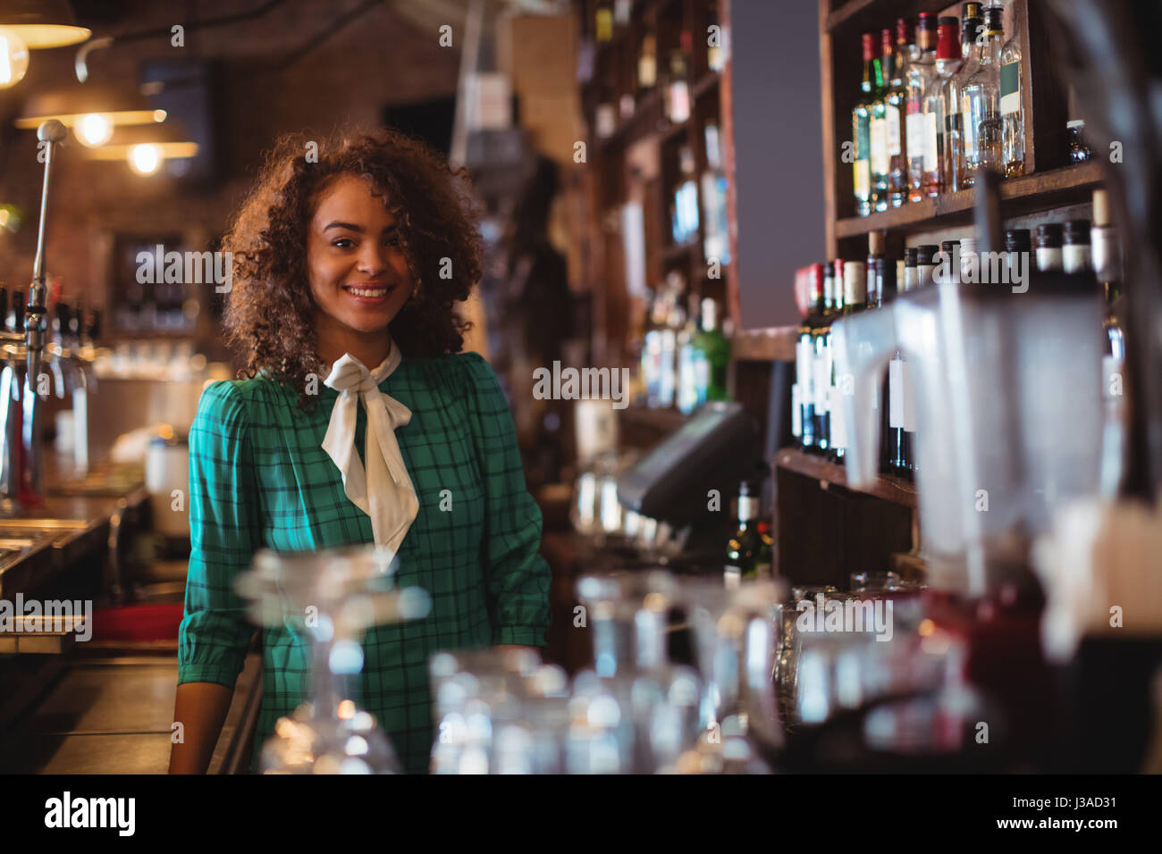 Portrait of beautiful female bar tender standing at bar counter Stock ...