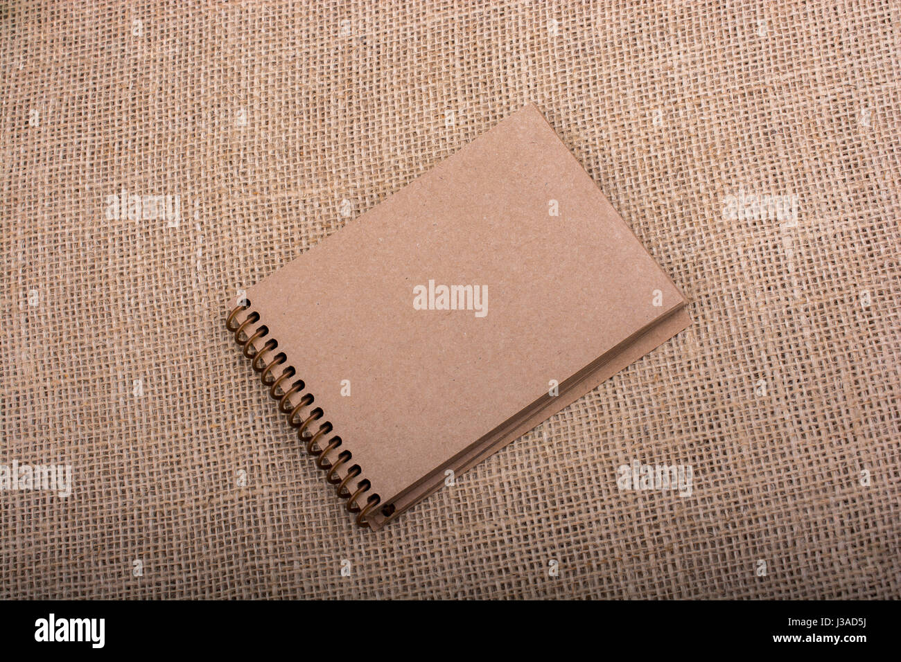 brown color notebook placed on a canvas background Stock Photo - Alamy