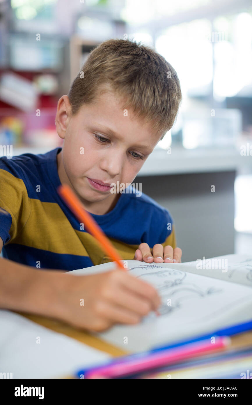 Boy drawing sketch on book at home Stock Photo - Alamy
