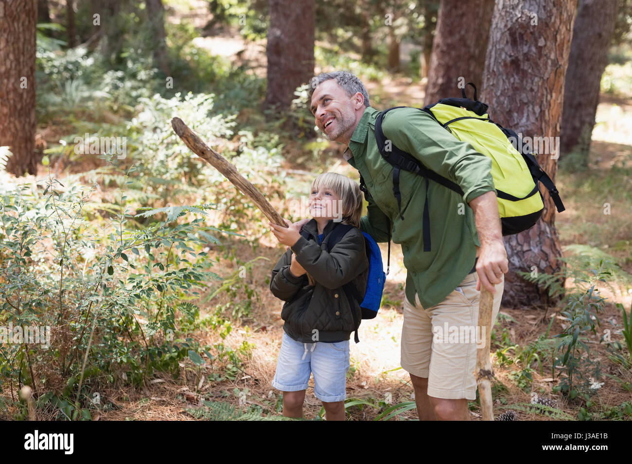 Cheerful father and son enjoying nature while hiking in forest Stock ...