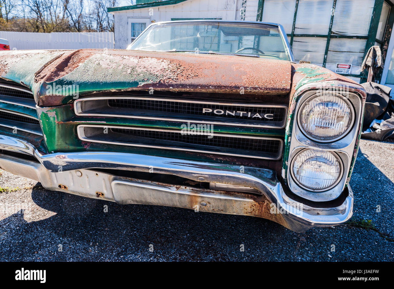 GOSHEN, VIRGINIA- APRIL 8 2017: Old car rusting away in front of an ...