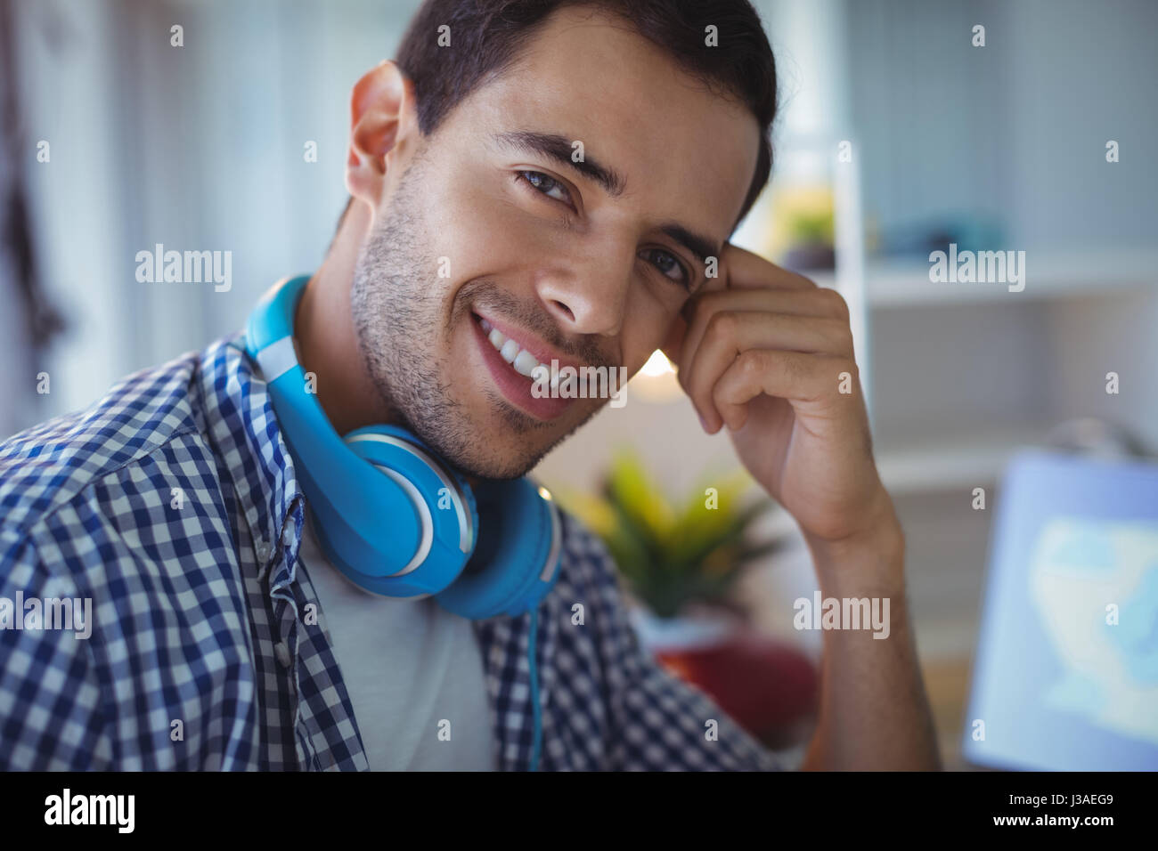 Portrait of smiling graphic designer sitting in office Stock Photo - Alamy