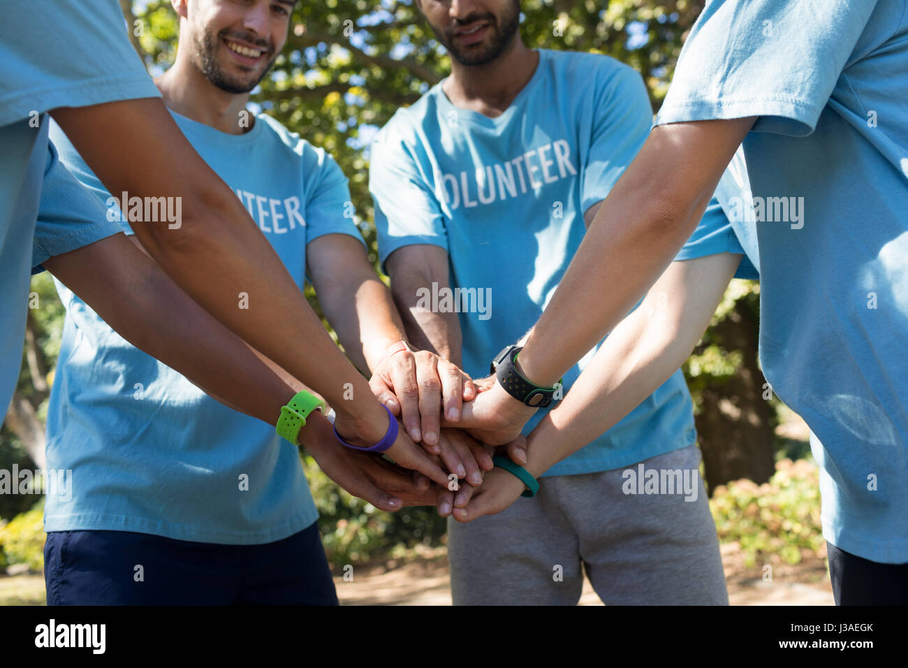 Volunteers forming a hand stack in the park Stock Photo - Alamy