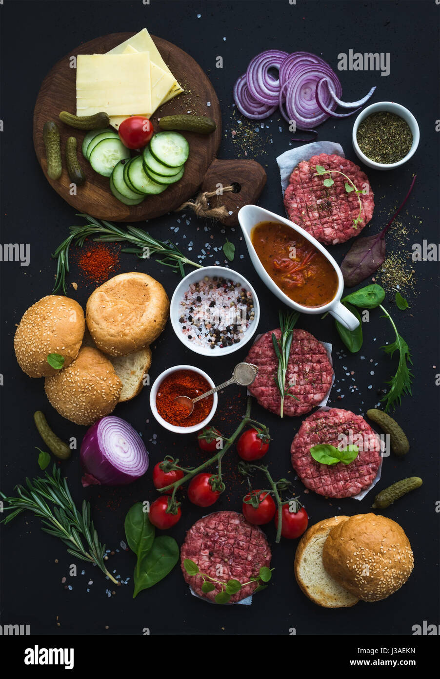 Ingredients for cooking burgers. Raw ground beef meat cutlets, buns ...