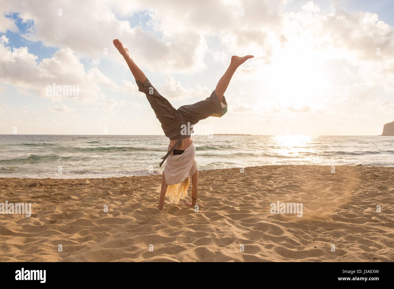 Woman turning cartwheel hi-res stock photography and images - Alamy