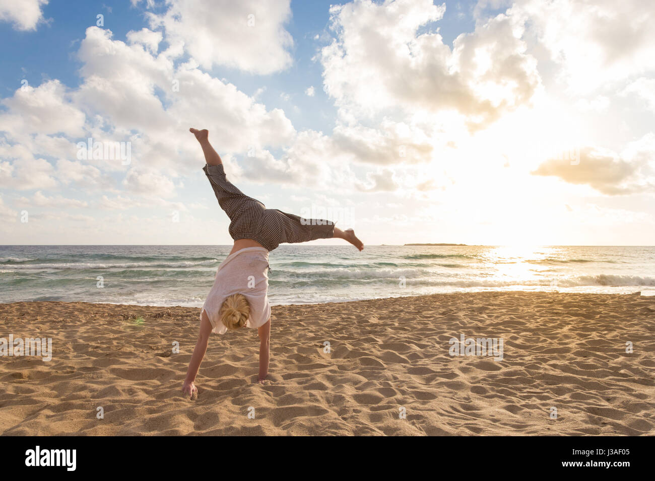 Woman turning cartwheel hi-res stock photography and images - Alamy