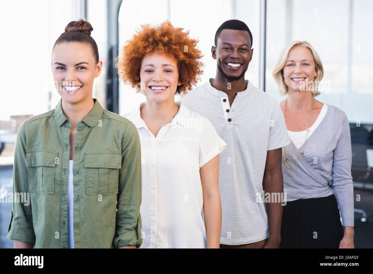 Portrait of smiling business people standing in row at office Stock ...