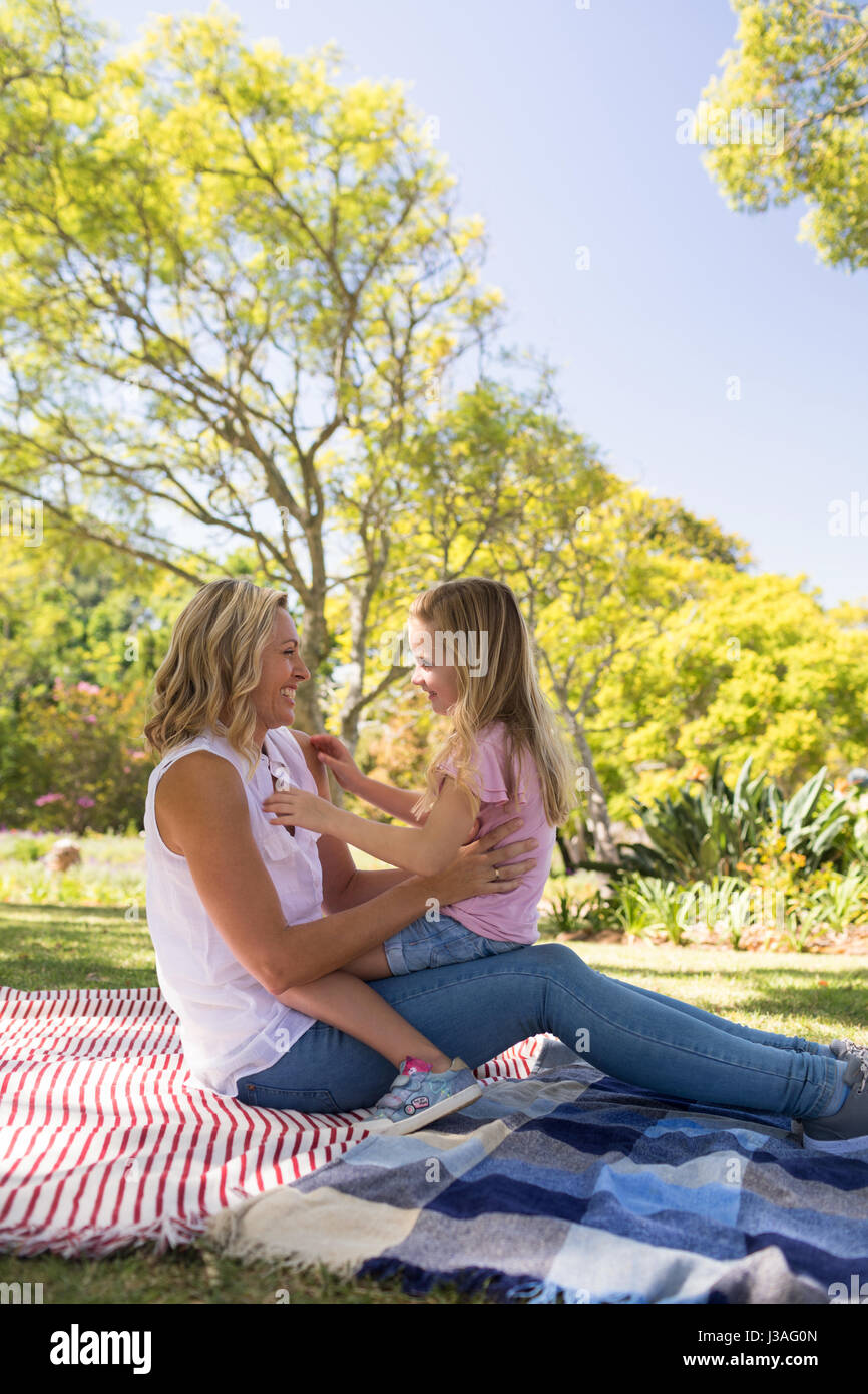 Happy mother embracing her daughter in park on a sunny day Stock Photo - Alamy