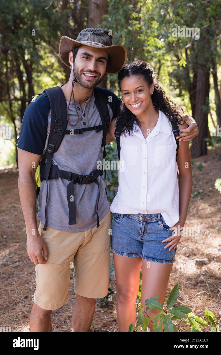 Portrait of young happy hiker couple standing in forest Stock Photo - Alamy