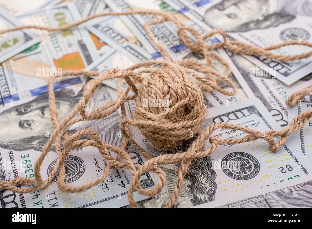Spool of linen spool is placed on spread US dollar Banknotes Stock ...