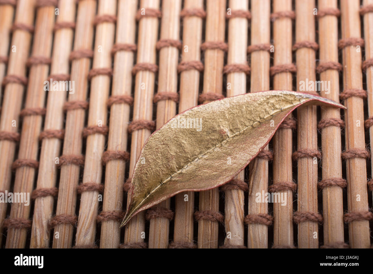 dry leaf on brown straw carpet background Stock Photo - Alamy