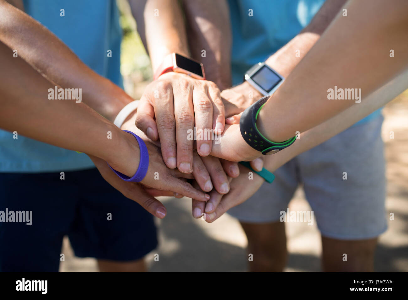 Close-up of marathon athletes forming a hands stack Stock Photo - Alamy
