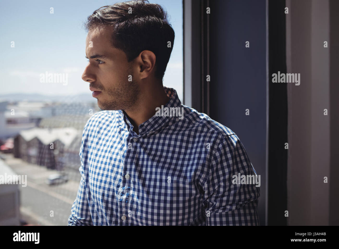 Close up of thoughtful businessman looking through glass window Stock ...